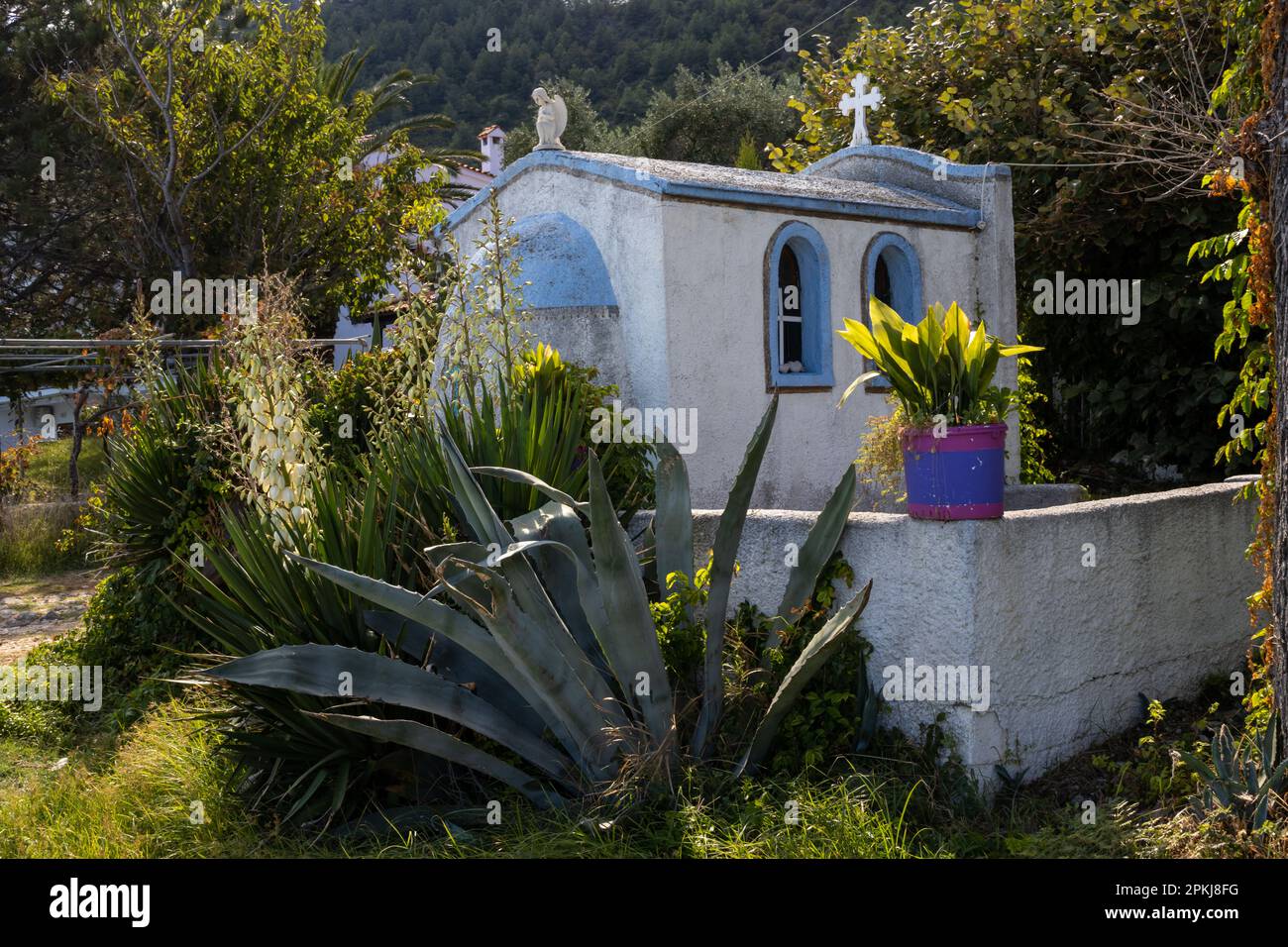 Blue chapel with a cross and angel on the roof, built in a beautiful ...