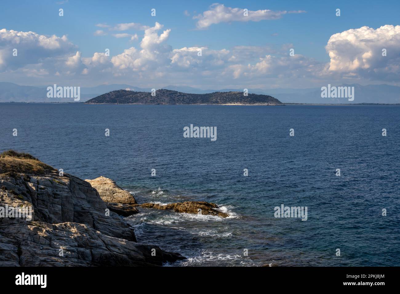 Blue color of the sea with small waves. Small island Thasopoula between ...