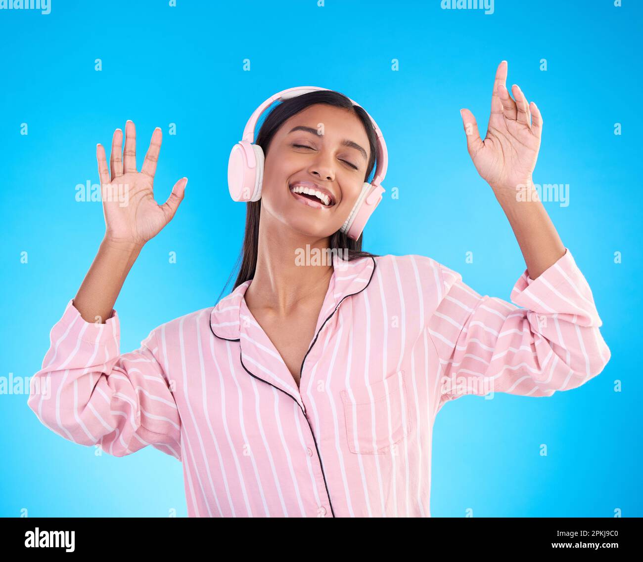 Smile, dance and woman in pajamas, headphones and inspiration against a ...