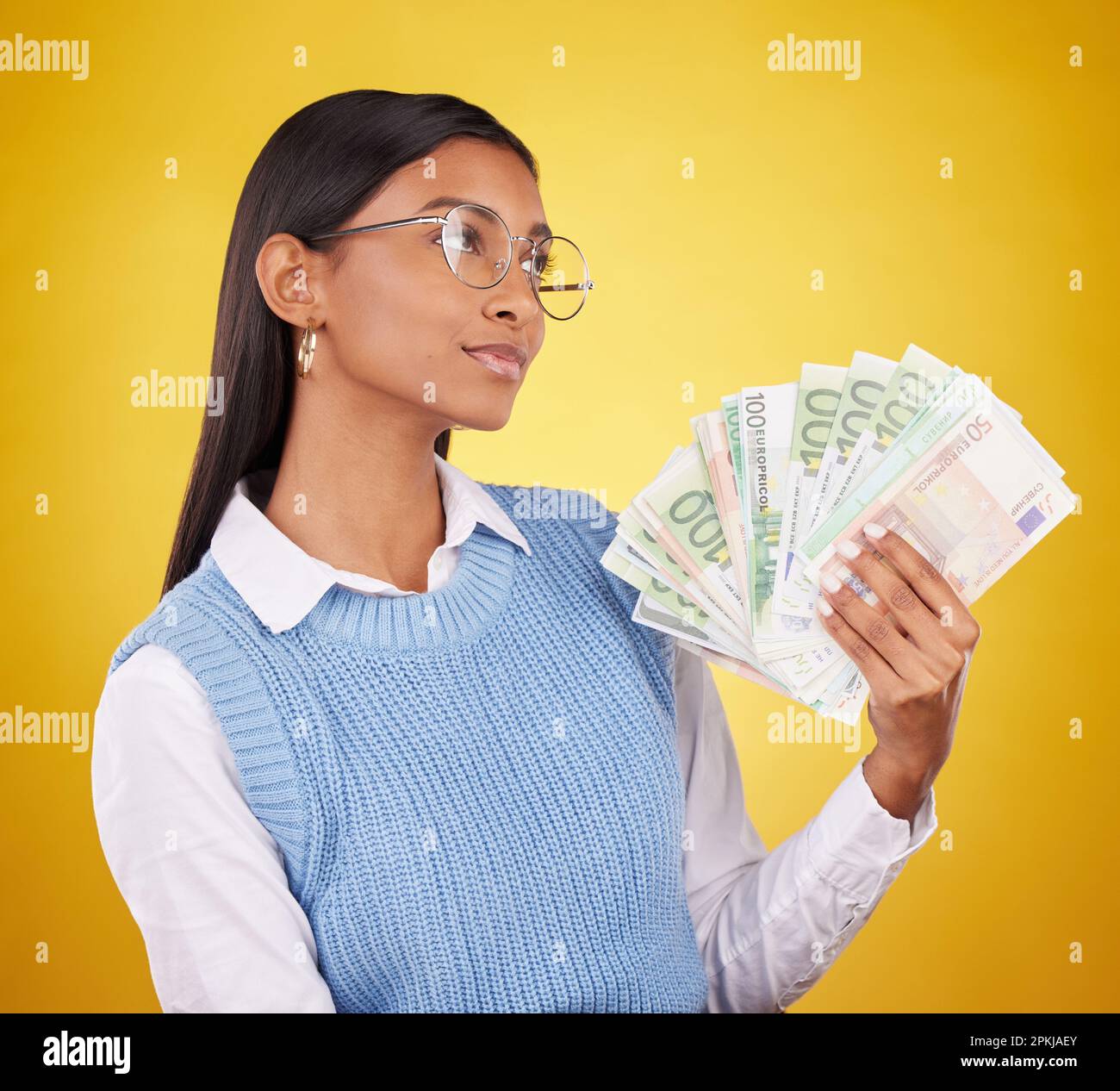 Young woman and money fan isolated on studio background of wealth, cash ...