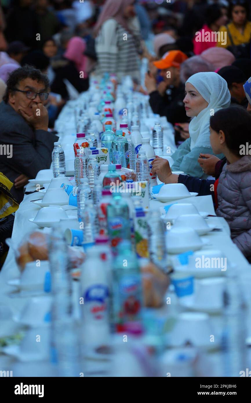 People gather for a mass Iftar, breaking of fast, in the holy month of Ramadan, in Algiers ...