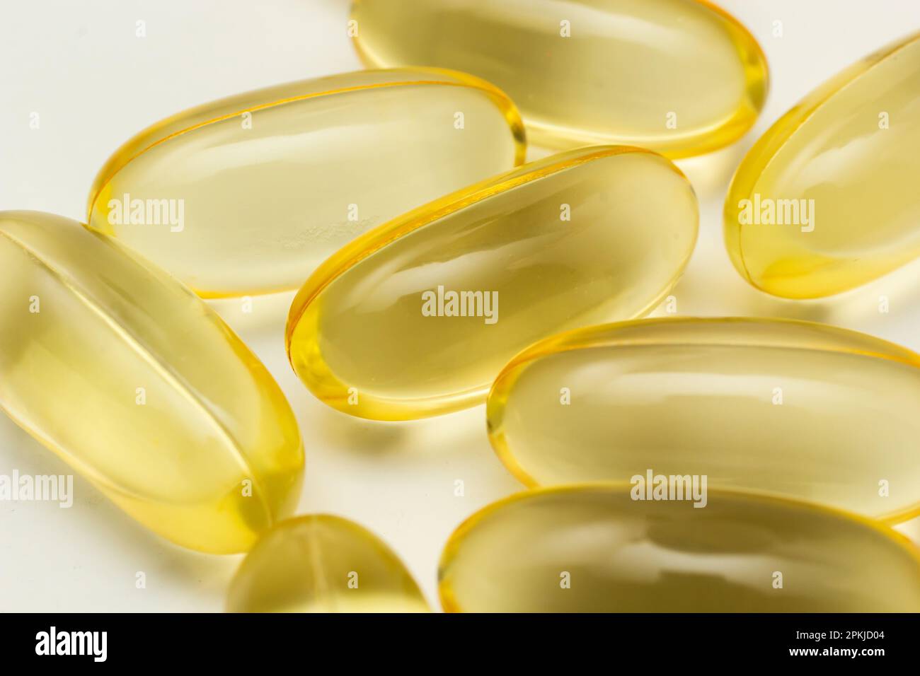 Fish oil capsules omega 3 on light background. Transparent yellow ...