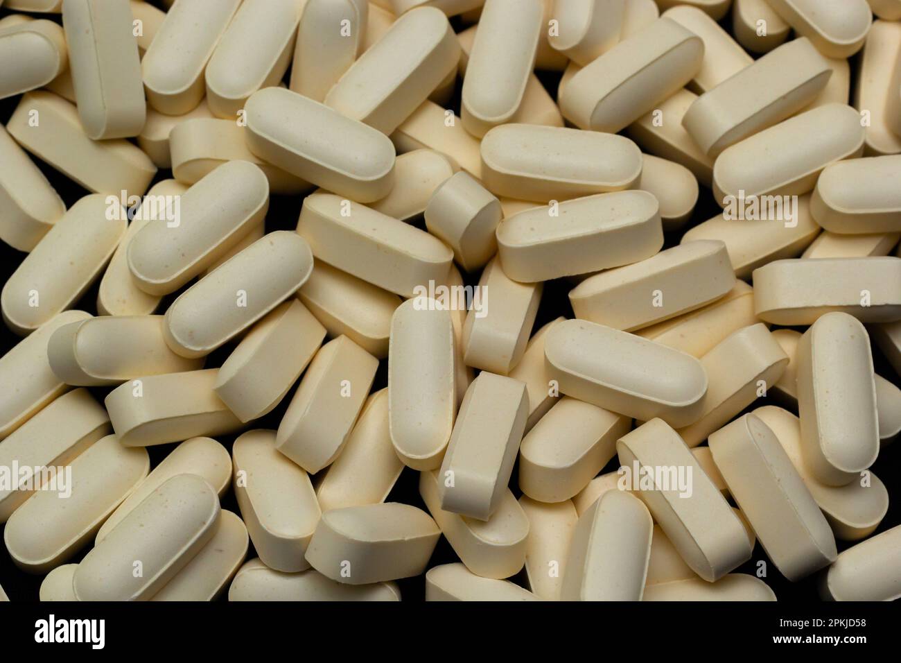 White capsules, pills on a black background. Medicine, healthcare ...