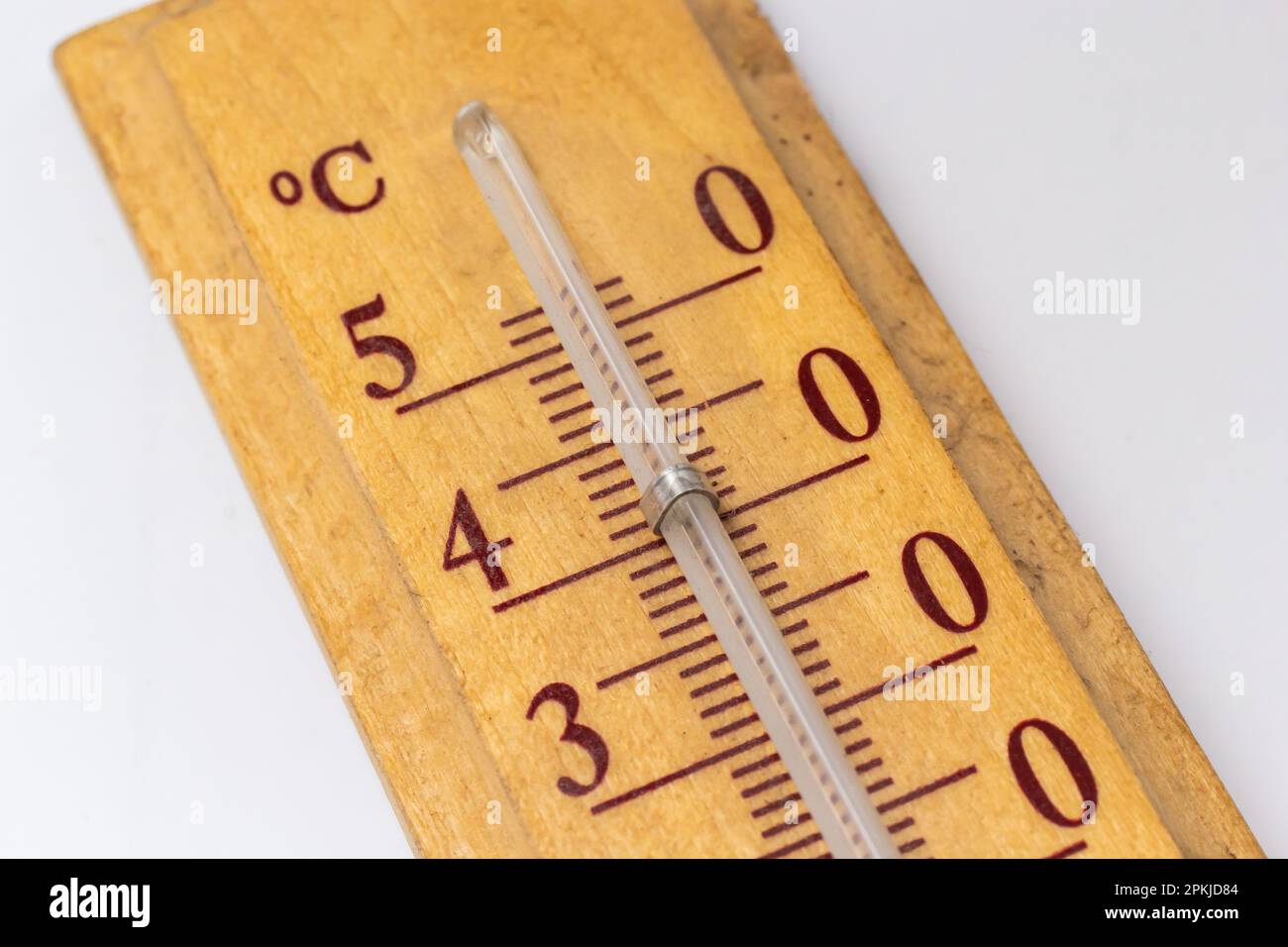 room thermometer on a wooden base close up on a white background ...