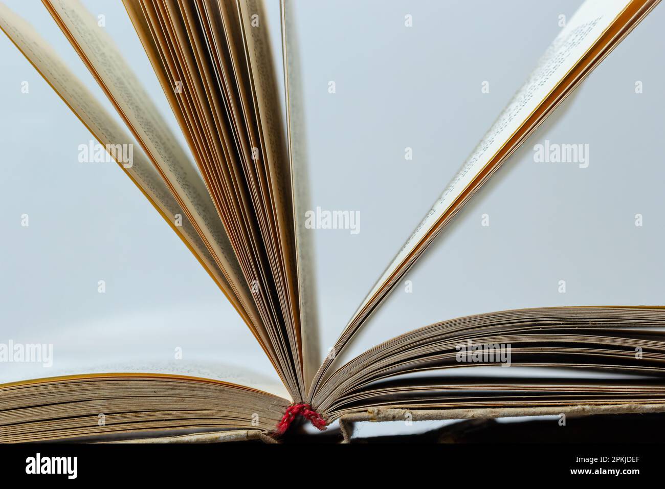 Open old book with text on white background. The concept of reading ...