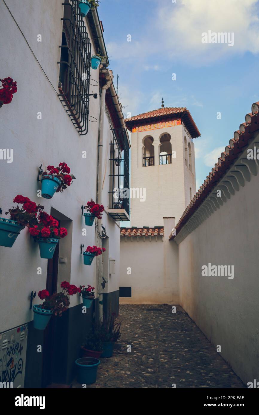 Charming white street with flowers and a moorish mosque in the Albacin ...