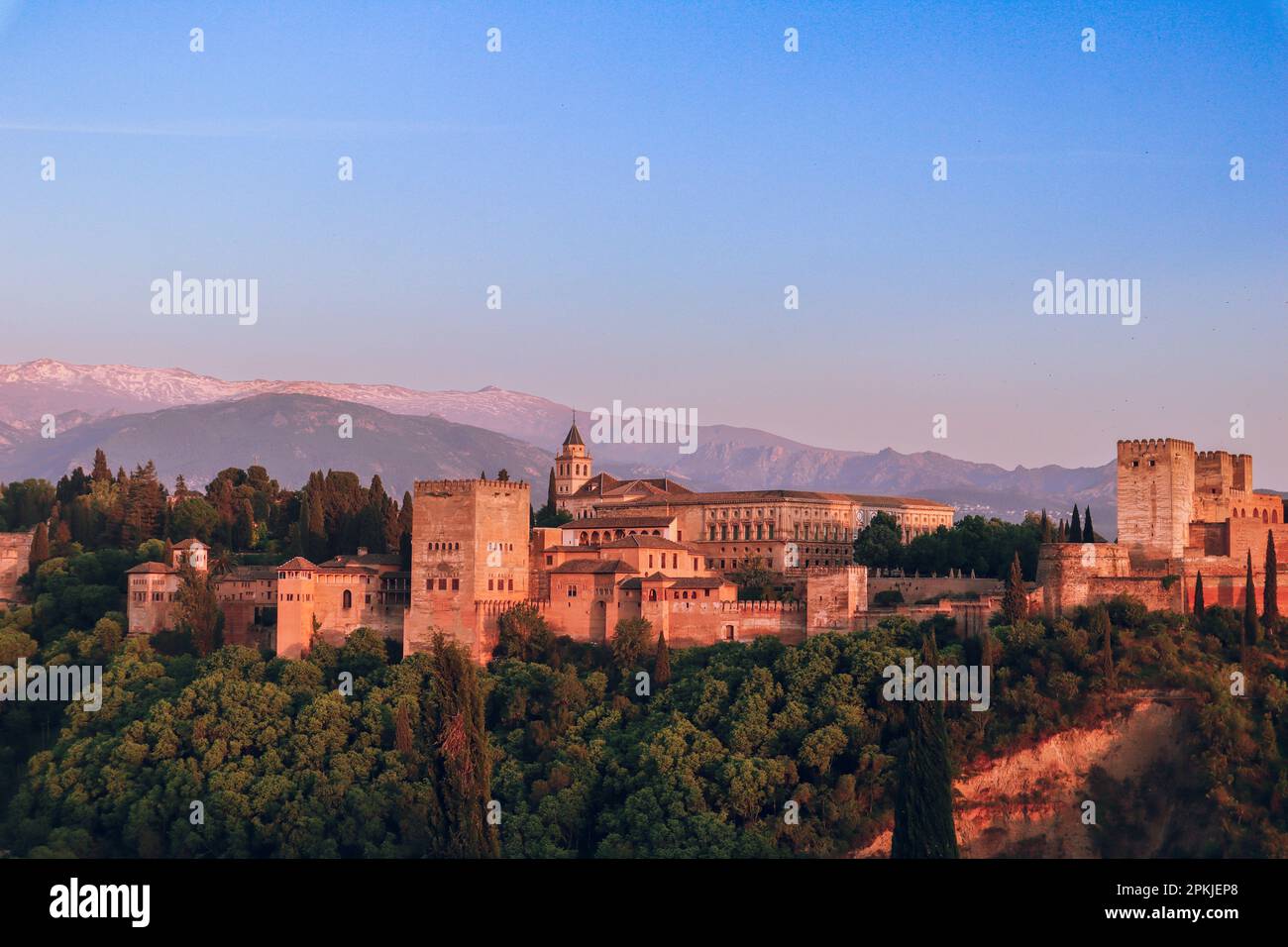 Sunset over Alhambra Palace and the Sierra Nevada mountains in Granada ...