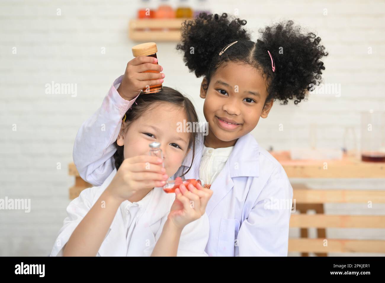 Kids with science lab coat studying and learning in science at school ...