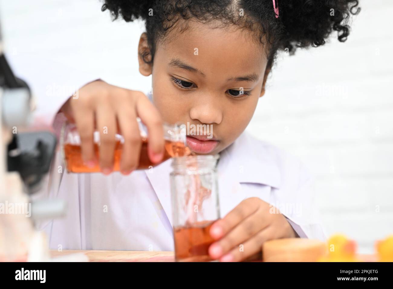 Kids with science lab coat studying and learning in science at school ...