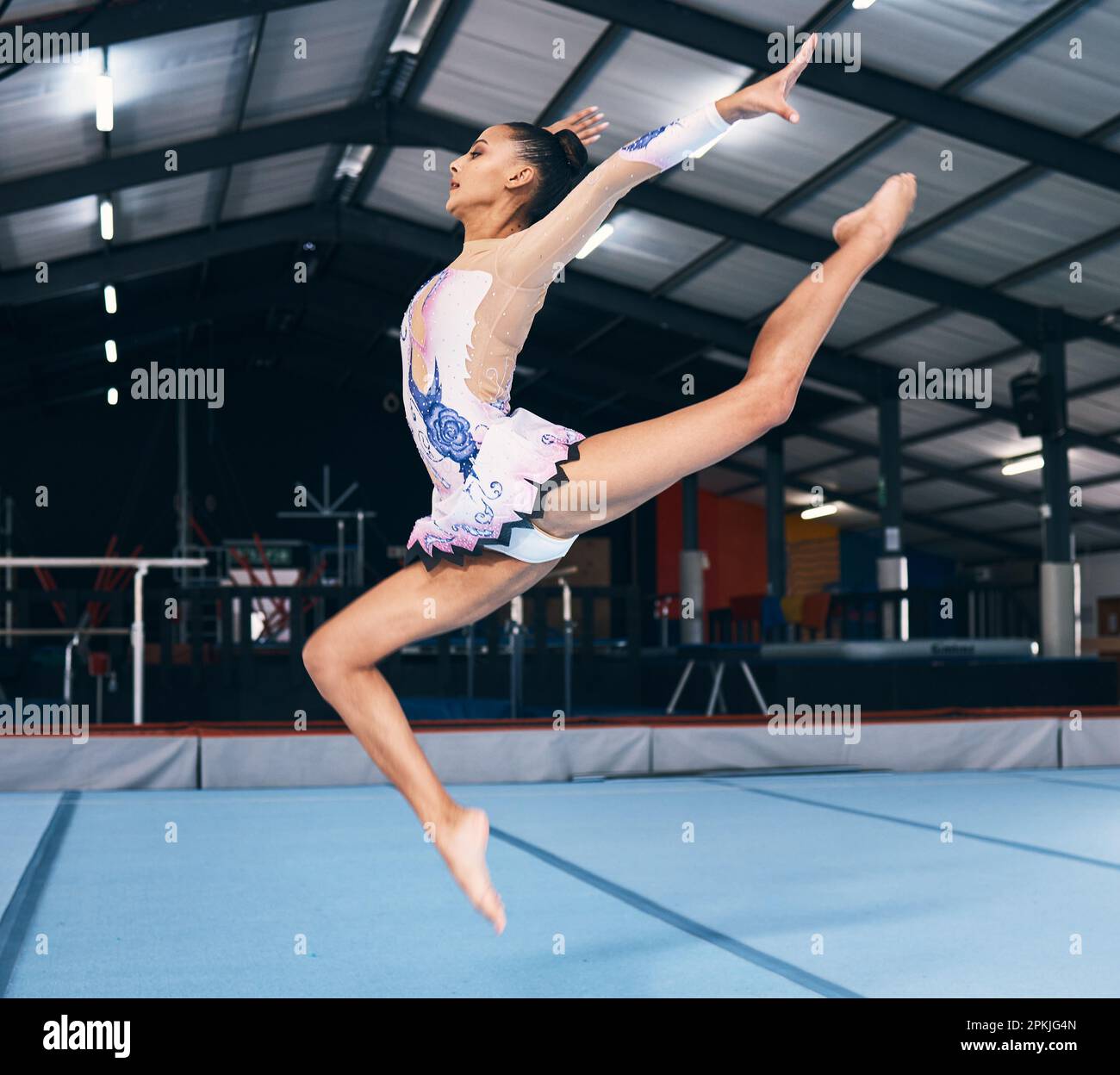 Woman, gymnastics and jump for performance, flexible dance skill and ...