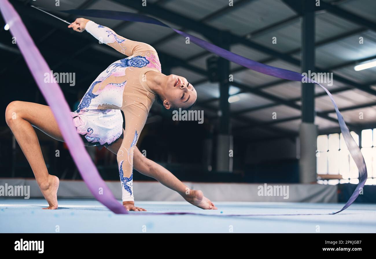 Ribbon, gymnastics and flexible woman stretching in performance, dance ...