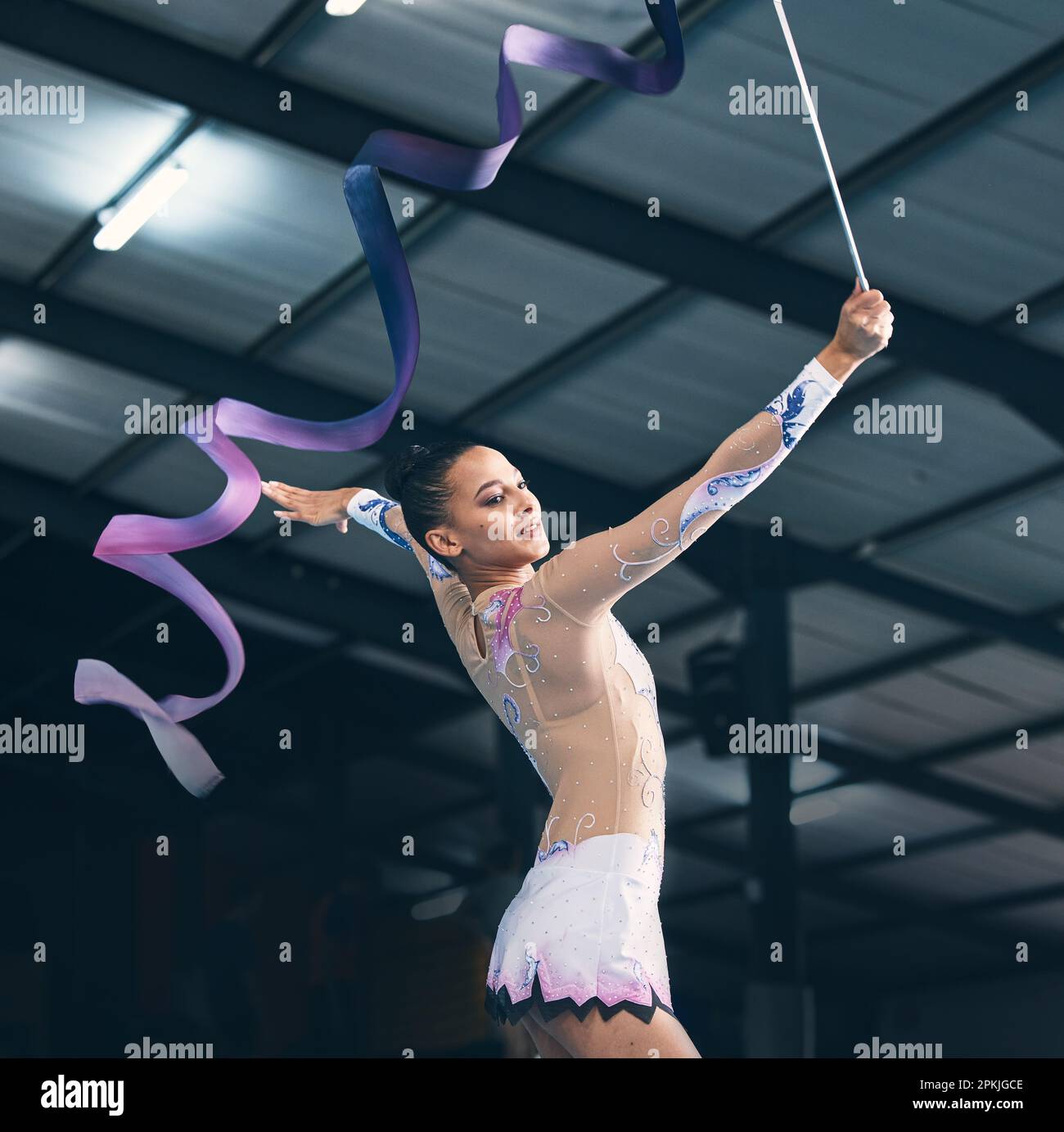 Ribbon gymnastics, woman and dancing in performance, training show and sports competition. Young ...