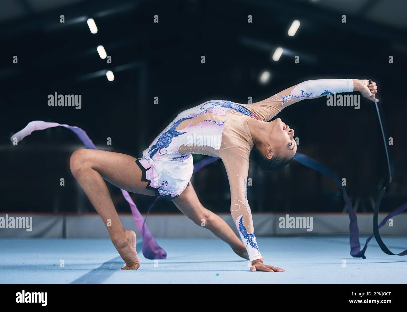 Ribbon, gymnastics and flexible woman stretching in performance, dance ...