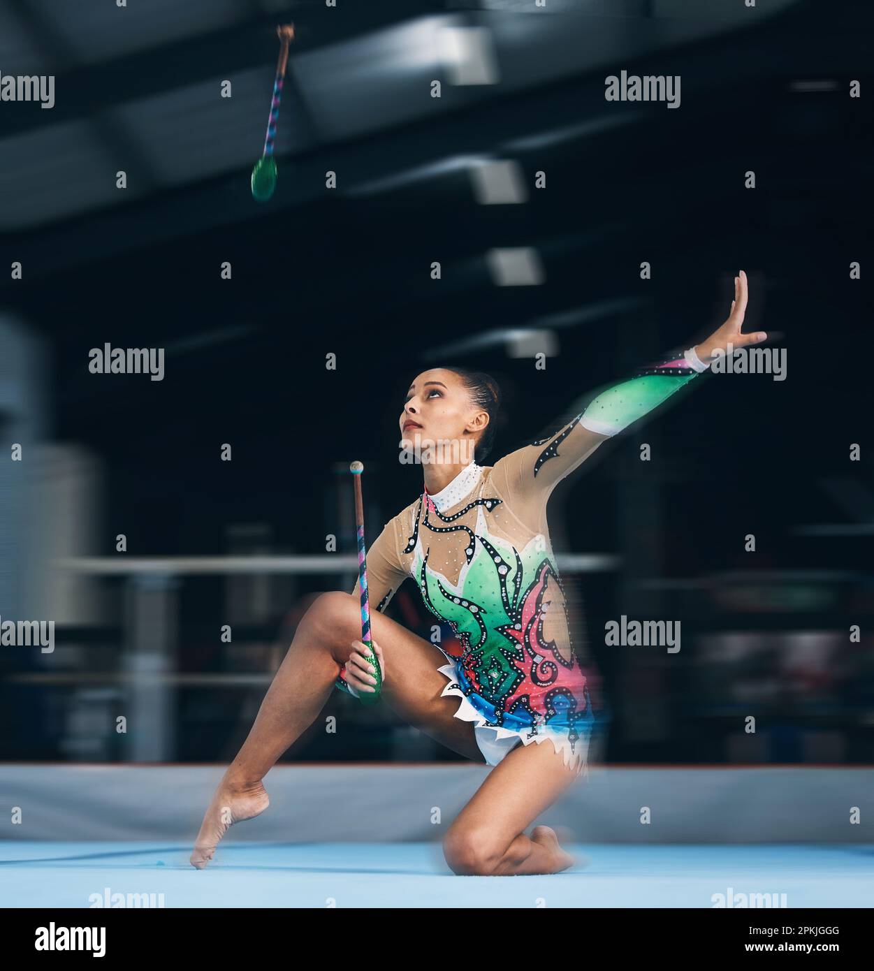 Woman, gymnast and dance sticks with balance and focus in a gym for ...