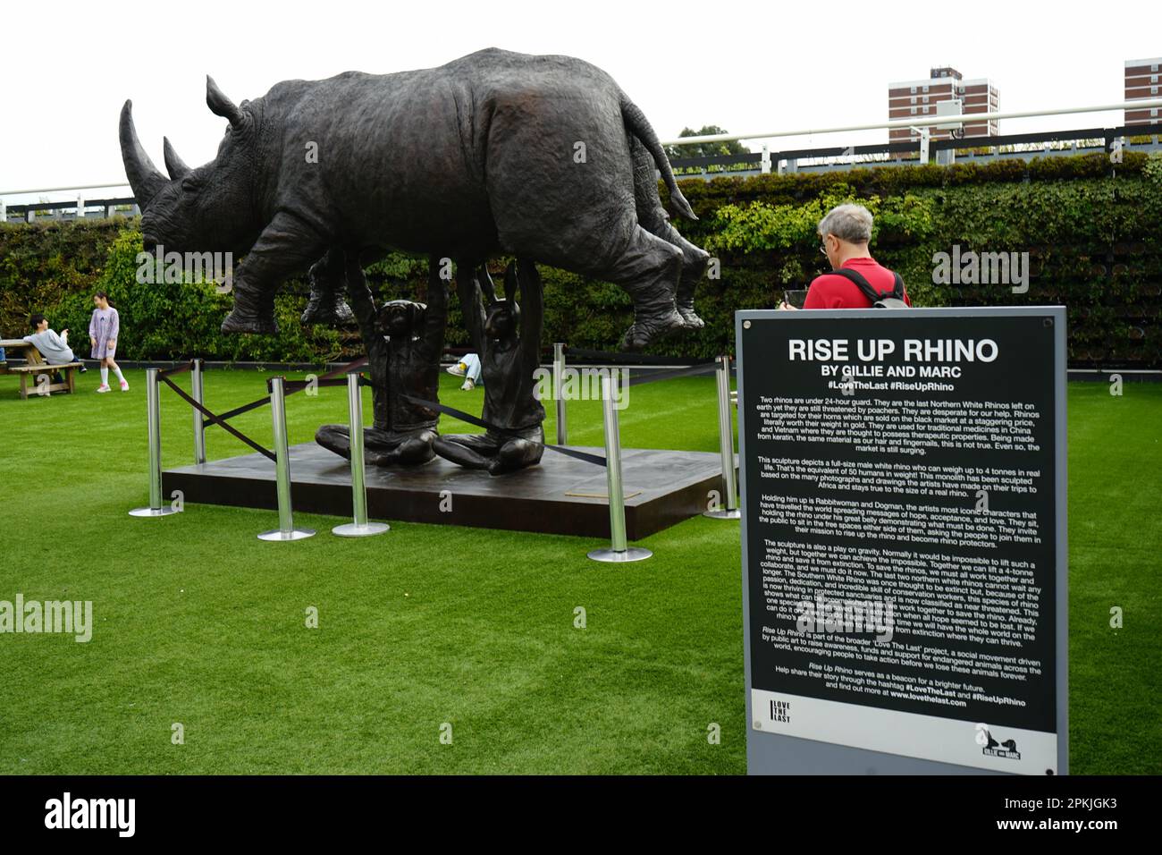 Family with “Rise Up Rhino,” a bronze sculpture by artists Gillie ...
