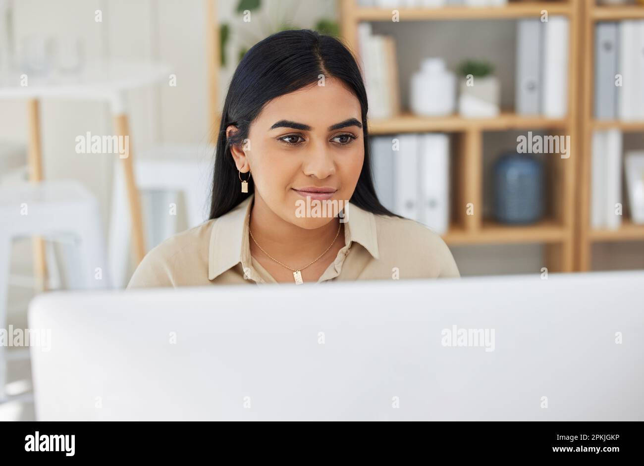 Business, reading or Indian woman typing on computer working on email ...