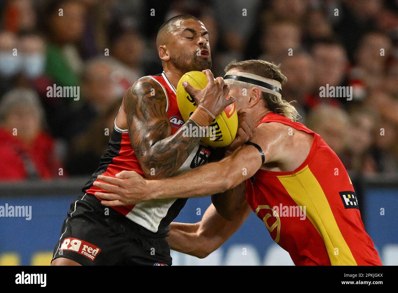 Nick Holman of the Suns tackles Bradley Hill of the Saints during the ...