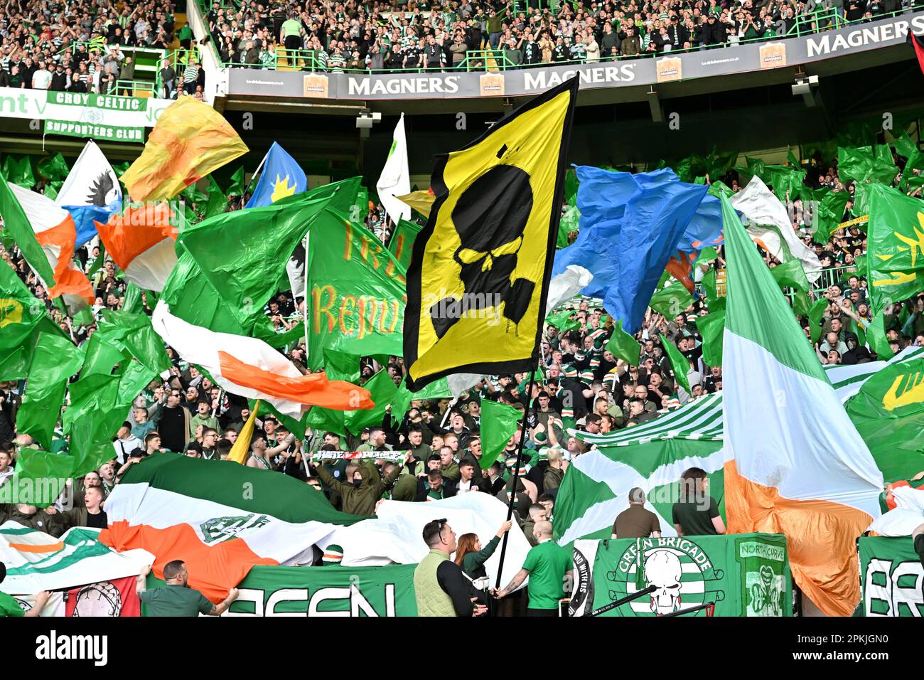 Celtic fans in the stands wave flags in support during the cinch ...