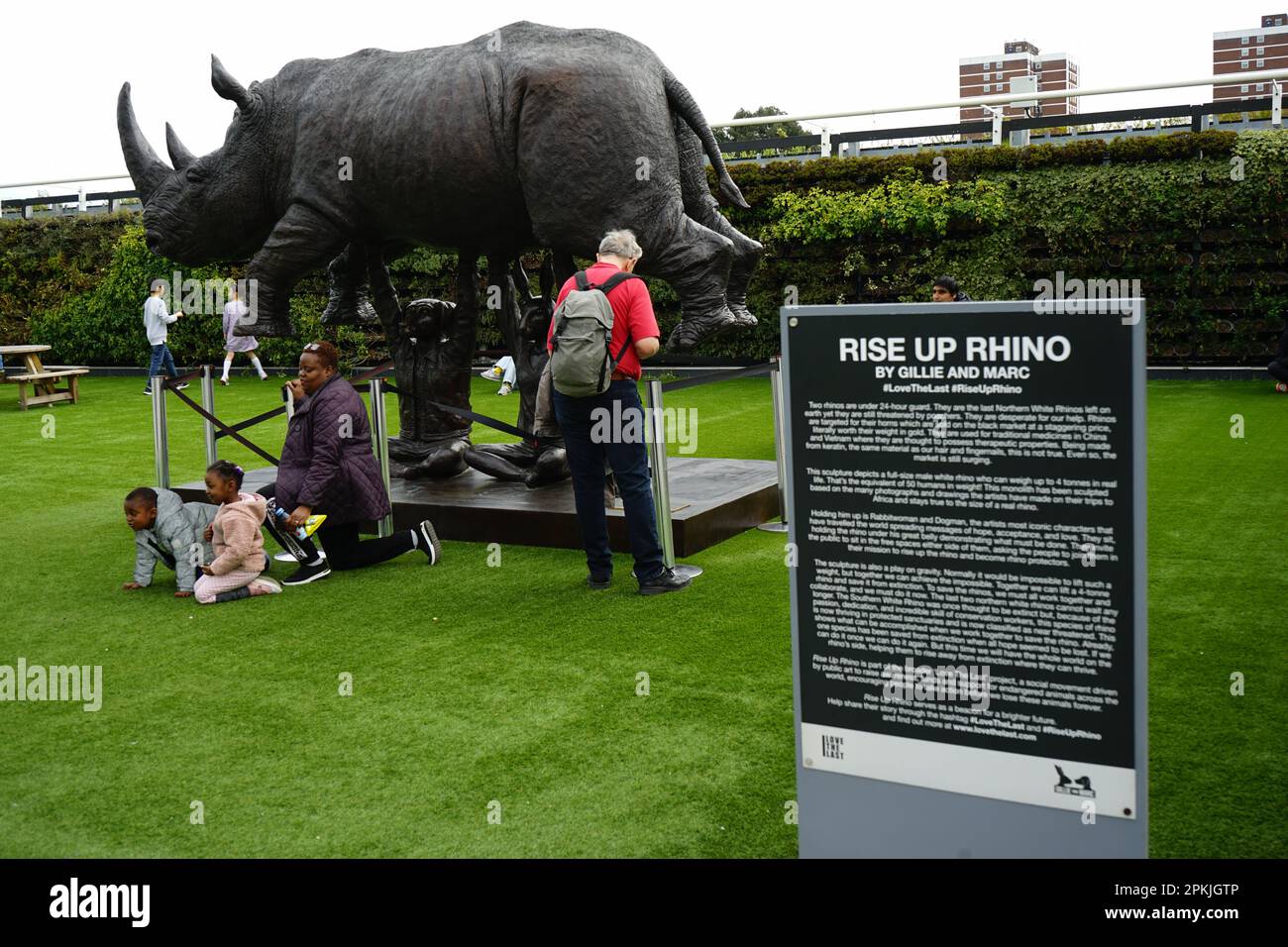 Family with “Rise Up Rhino,” a bronze sculpture by artists Gillie ...
