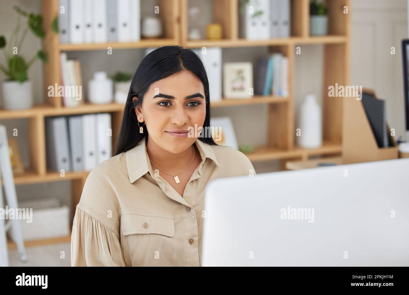Business, digital or Indian woman typing on computer working on email ...