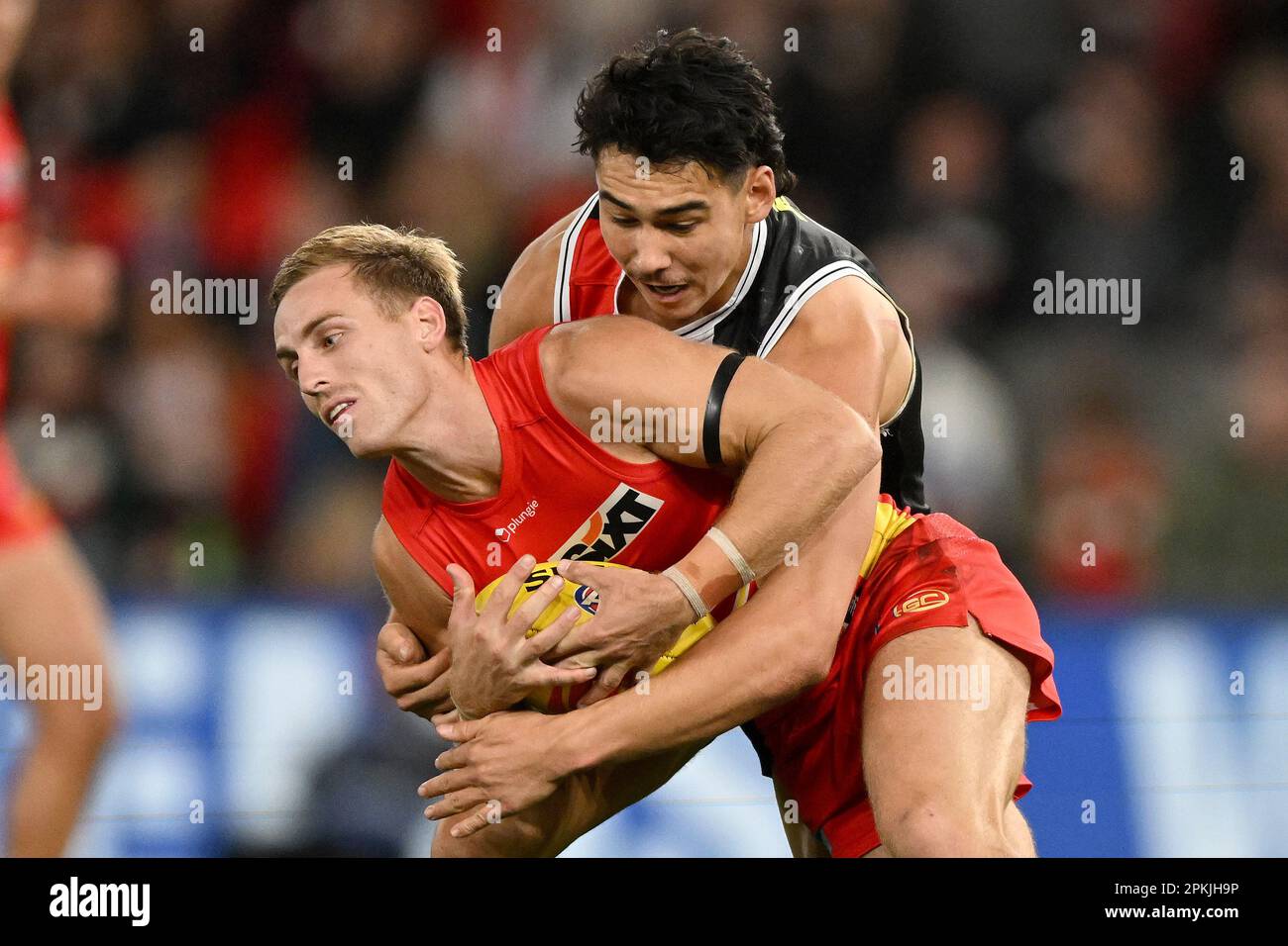 Mitch Owens of the Saints tackles Darcy Macpherson of the Suns during ...