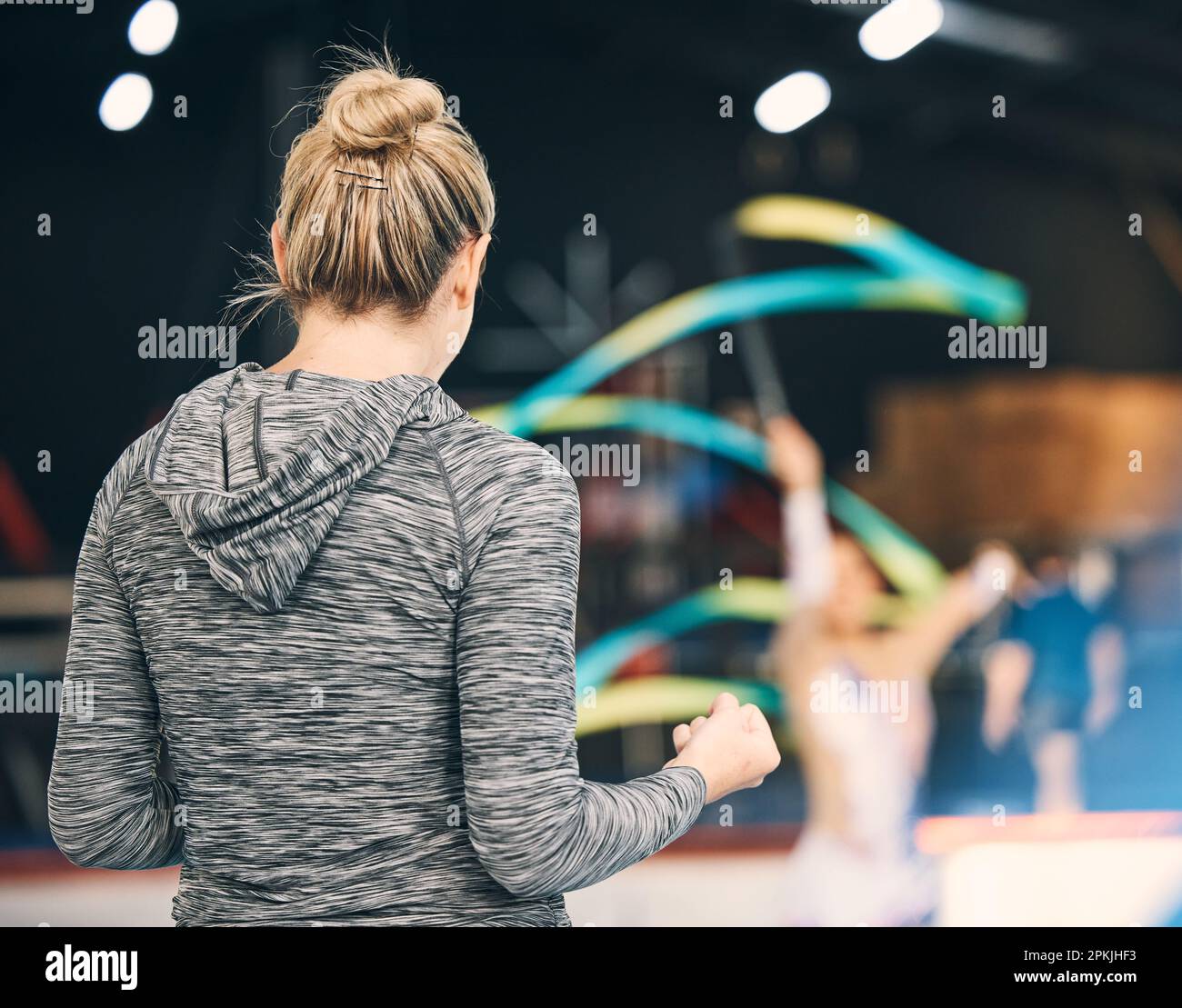 Coaching, gymnastics and cheering with woman in stadium for training, fitness and teaching ...