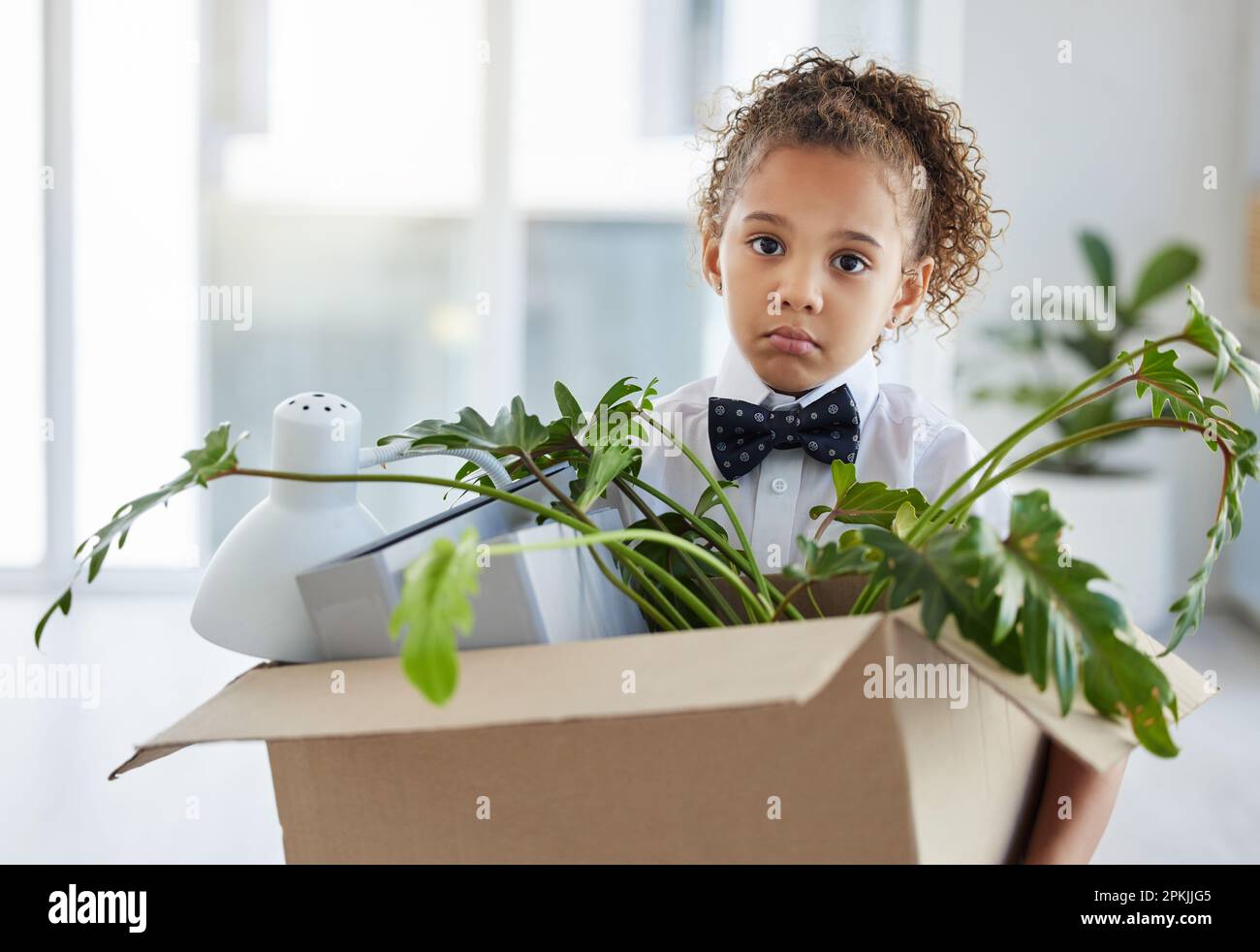 Sad, portrait and a child playing as a business person with a box of ...