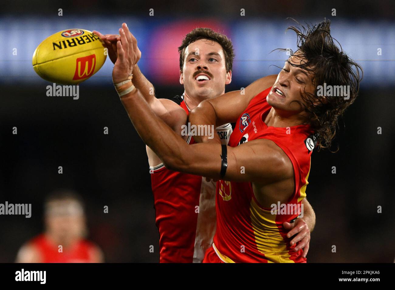 Zaine Cordy of the Saints and Ned Moyle of the Suns compete in the ruck ...