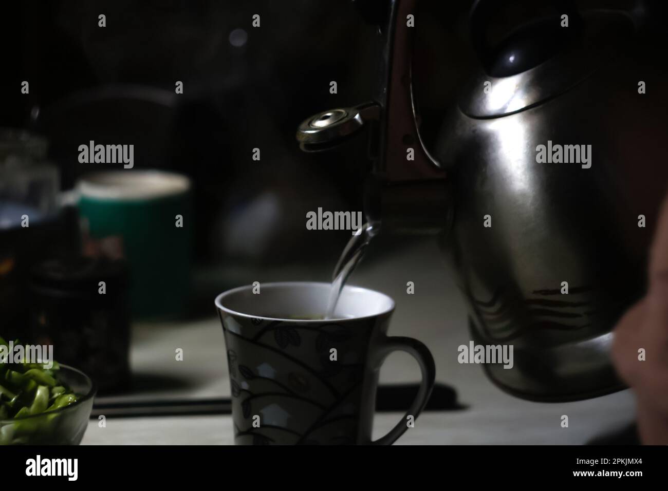 Kettle pouring into mug. Kettle pouring boiling water into a cup during ...