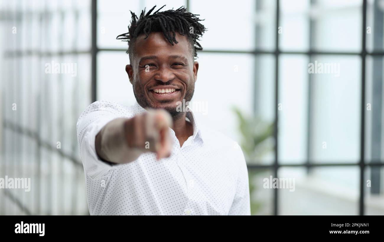 Handsome happy young man pointing at camera Stock Photo - Alamy