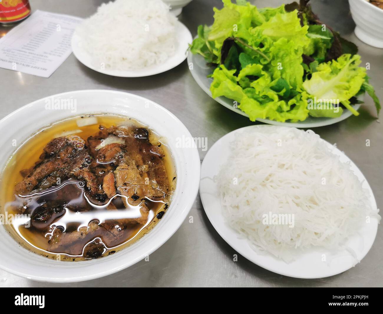 26 February 2023, Vietnam, Hanoi: A bun cha consisting of grilled pork ...