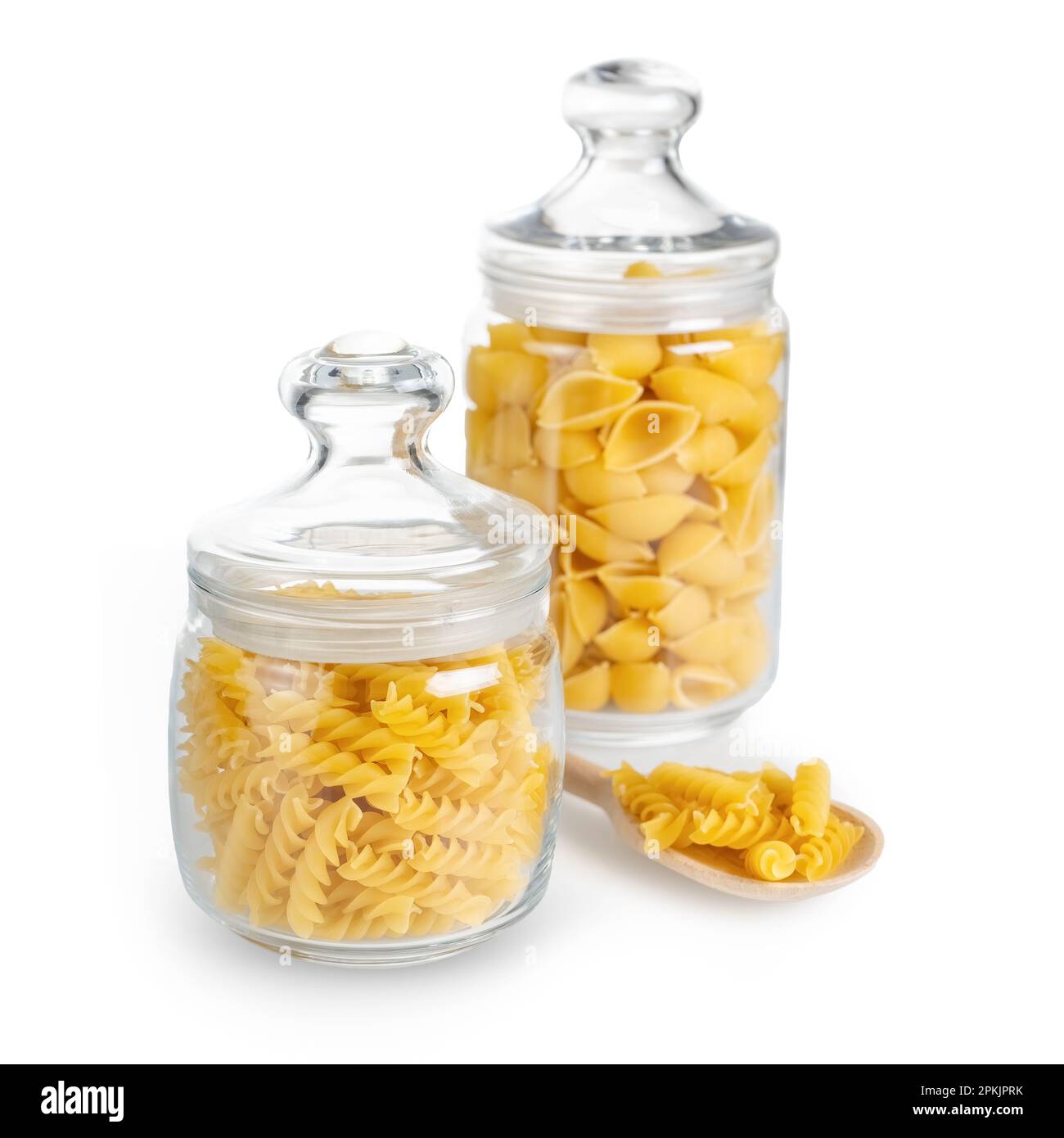 Fusilli and conchiglioni in glass jar isolated on white background. Two ...