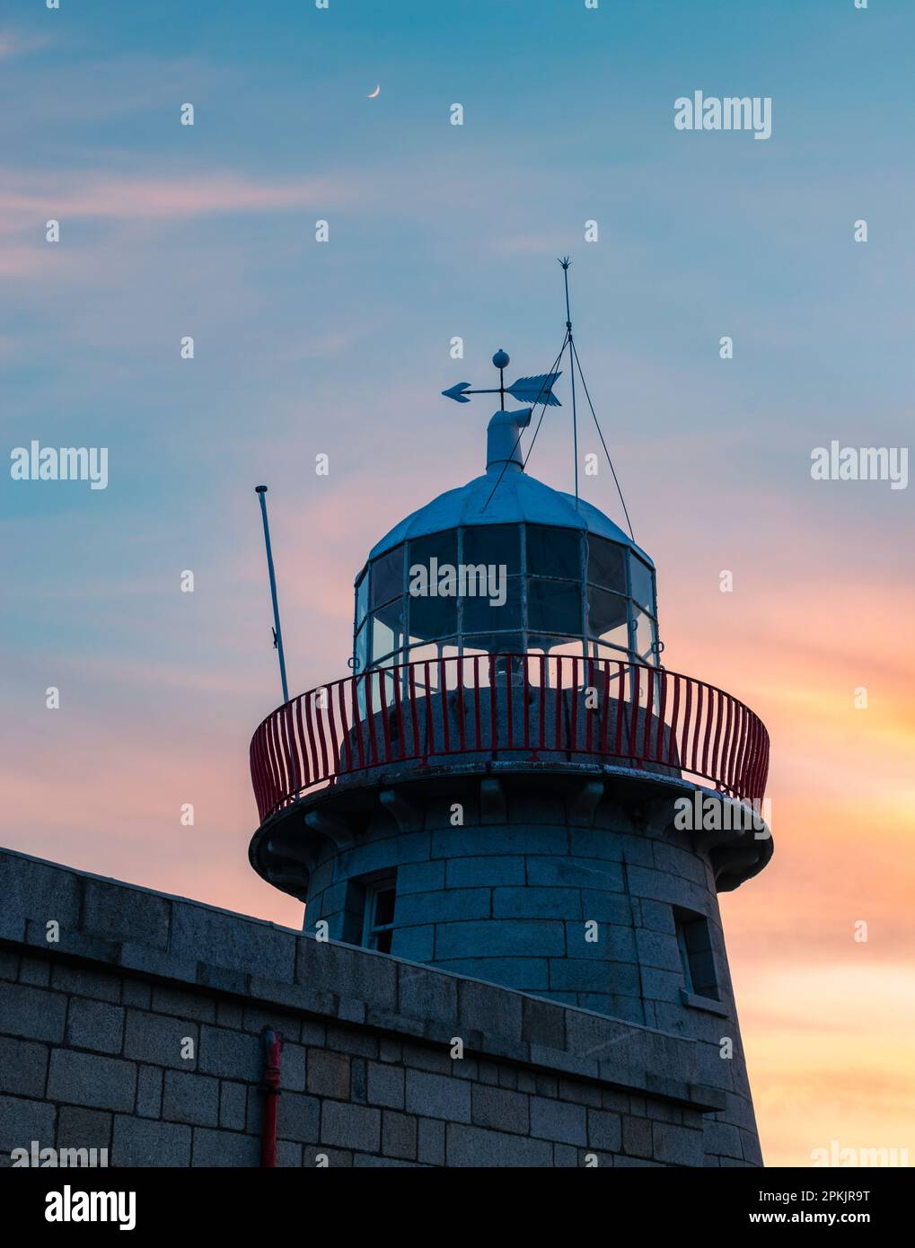 Sunset sky and crescent moon over Howth Lighthouse Stock Photo - Alamy
