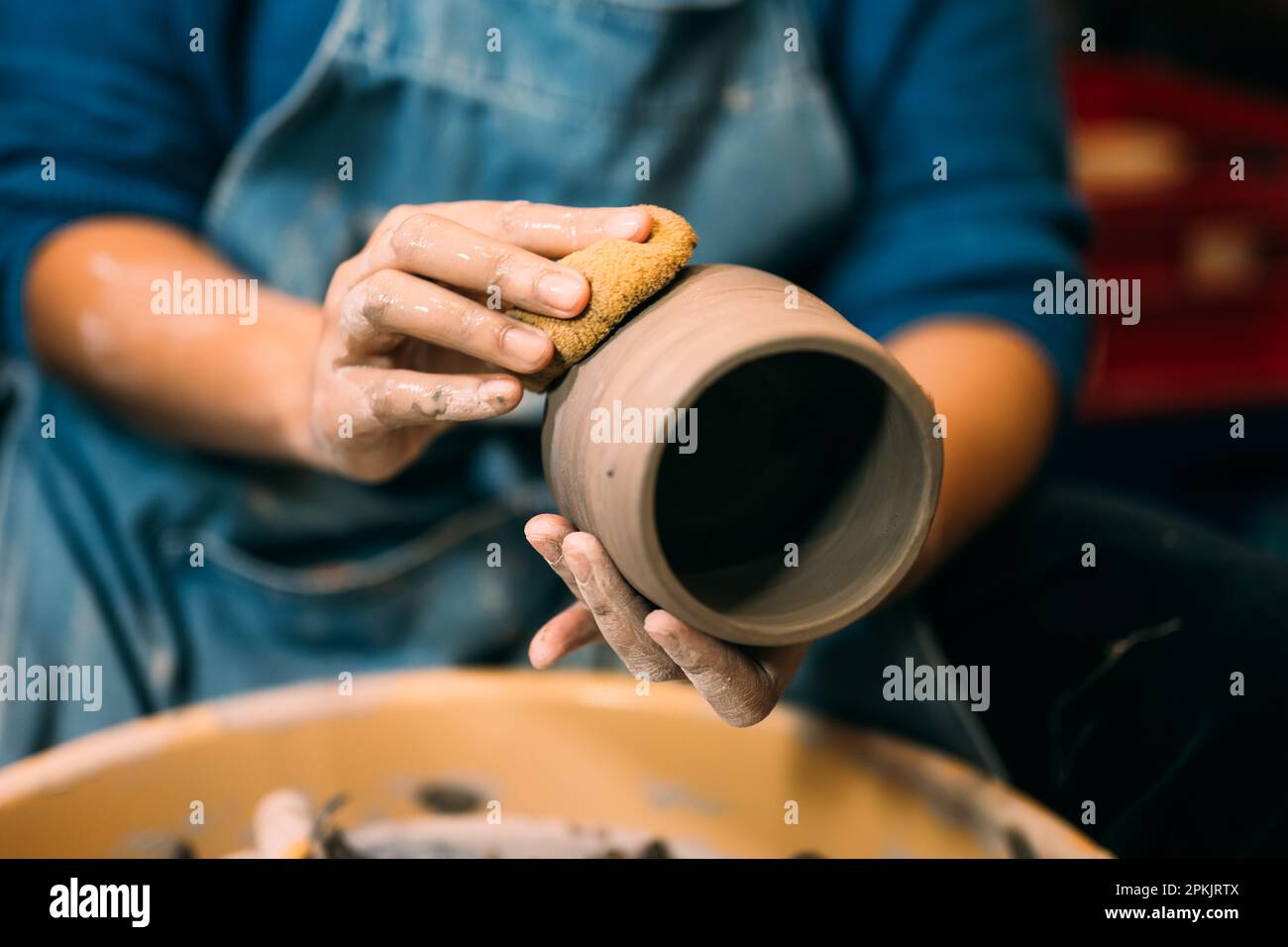 Craftsman potter making jug of clay on potter wheel circle in workshop Stock Photo - Alamy