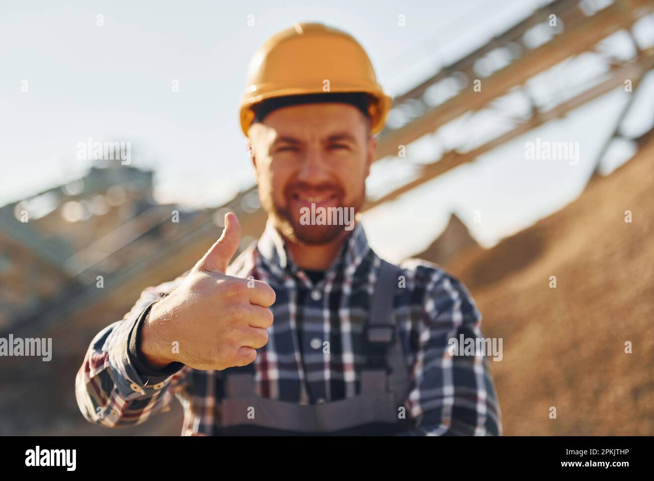 Positive man. Construction worker in uniform is on the quarry Stock ...