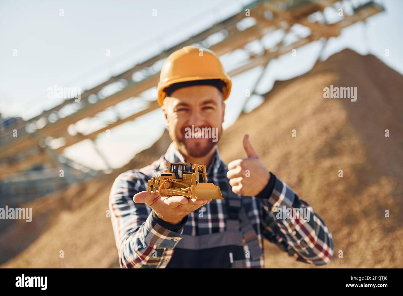 Positive man. Construction worker in uniform is on the quarry Stock ...