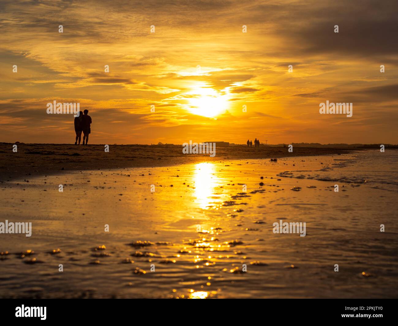 Golden hour silhouettes at Burrow Beach Stock Photo - Alamy