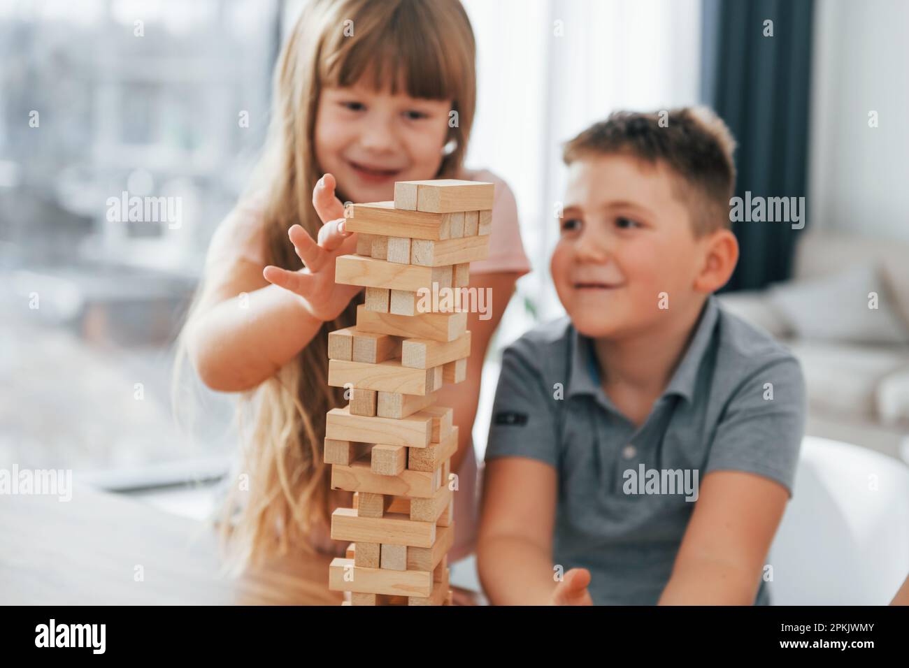 Building a tower. Playing game. Kids having fun in the domestic room at ...
