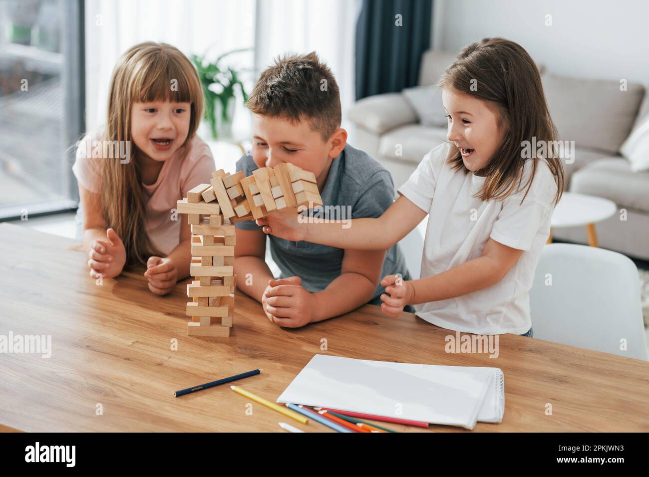 Building a tower. Playing game. Kids having fun in the domestic room at ...