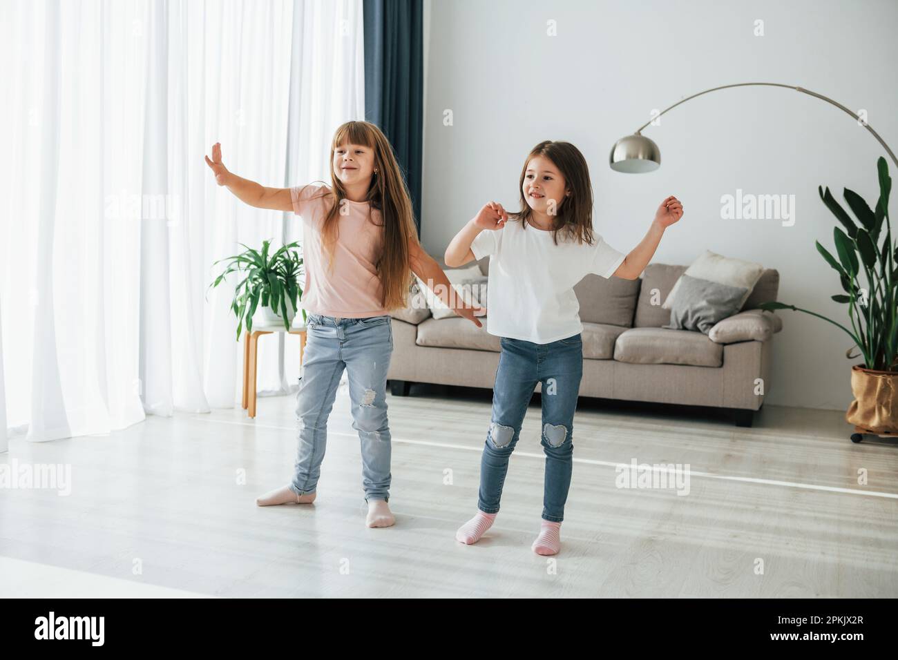 Dancing together. Kids having fun in the domestic room at daytime Stock ...