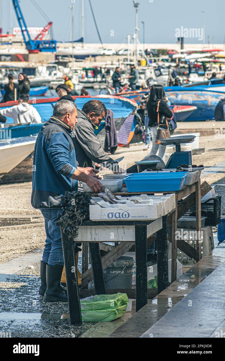 Local fishermen selling on the stalls raw fresh fish, sea fruits or ...