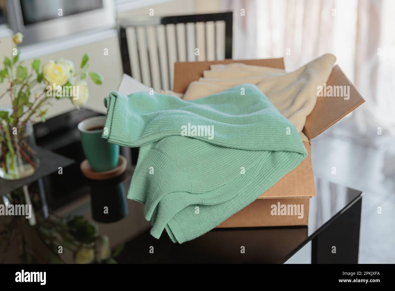 Second hand clothes in cardboard box, used wardrobe Stock Photo - Alamy