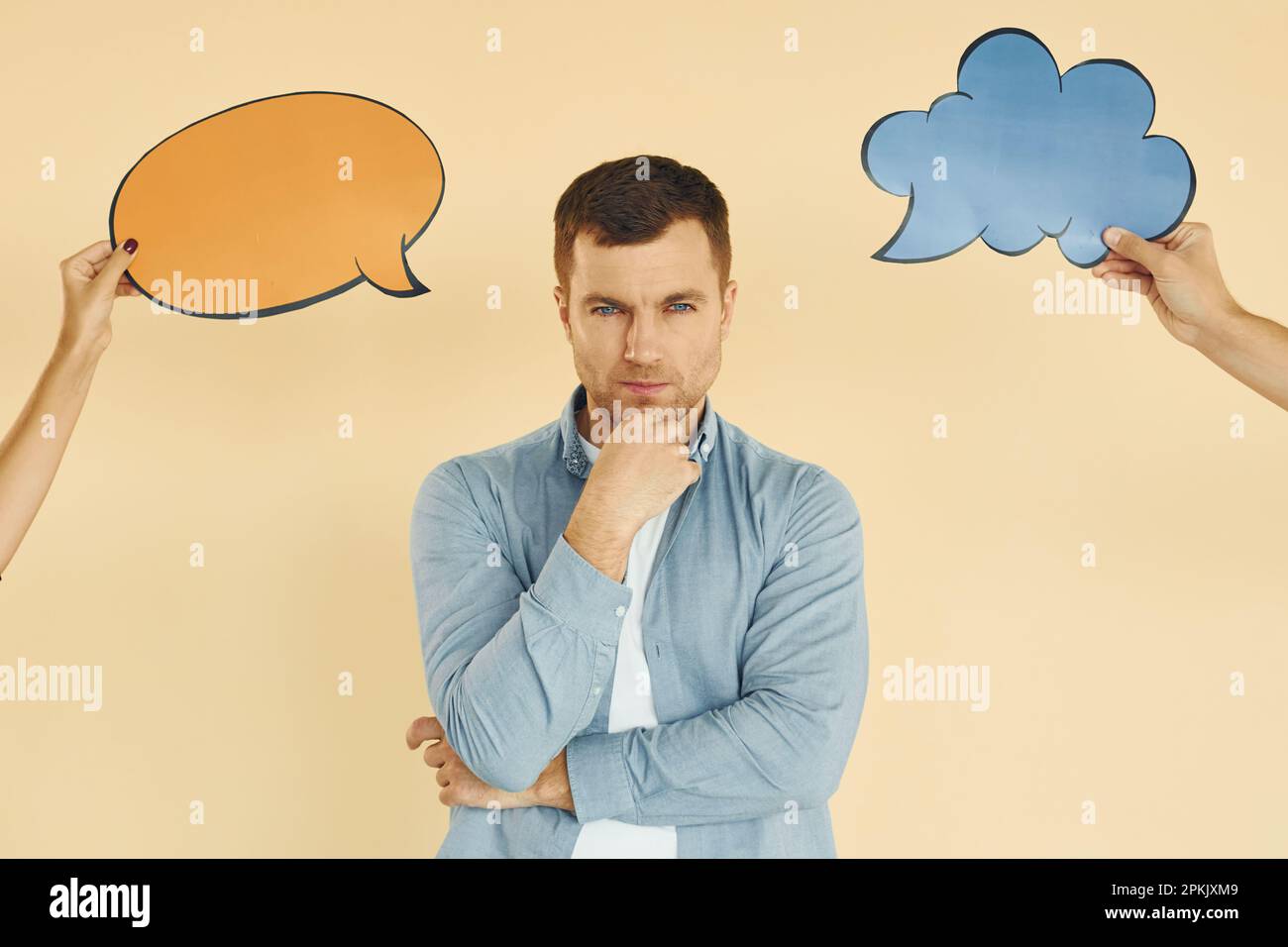 Tough choice between two ideas. Man standing in the studio with empty ...