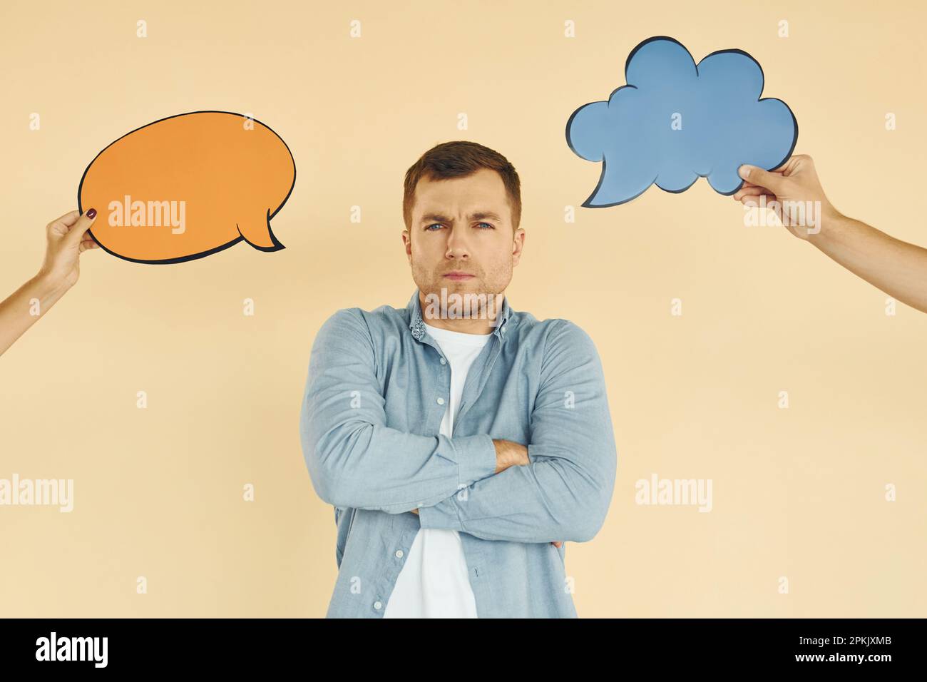 Thinking about two ideas. Man standing in the studio with empty signs ...