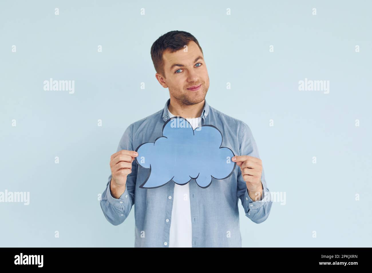Holding sign. Man standing in the studio Stock Photo - Alamy