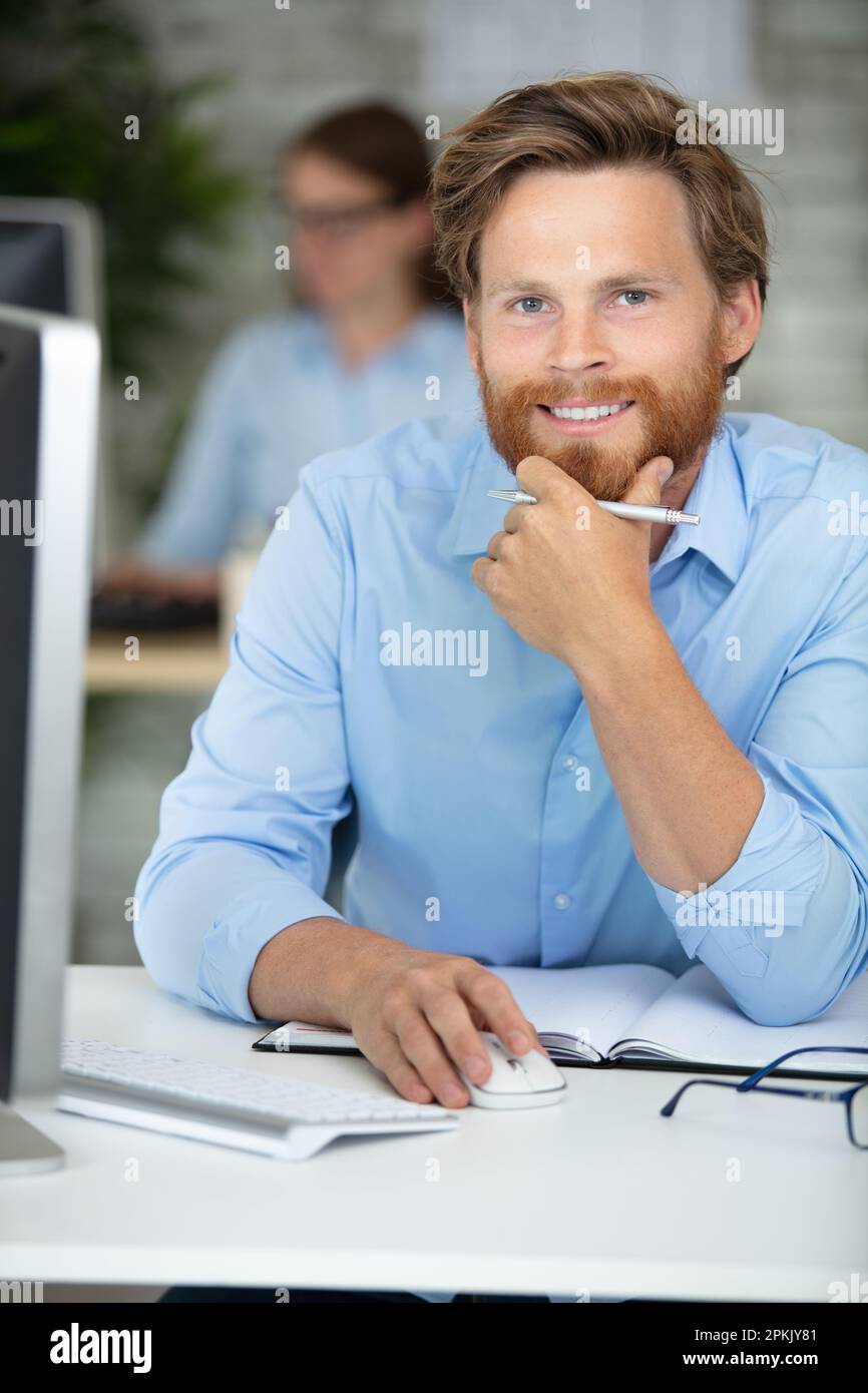 portrait of bearded businessman sat at computer desk Stock Photo - Alamy
