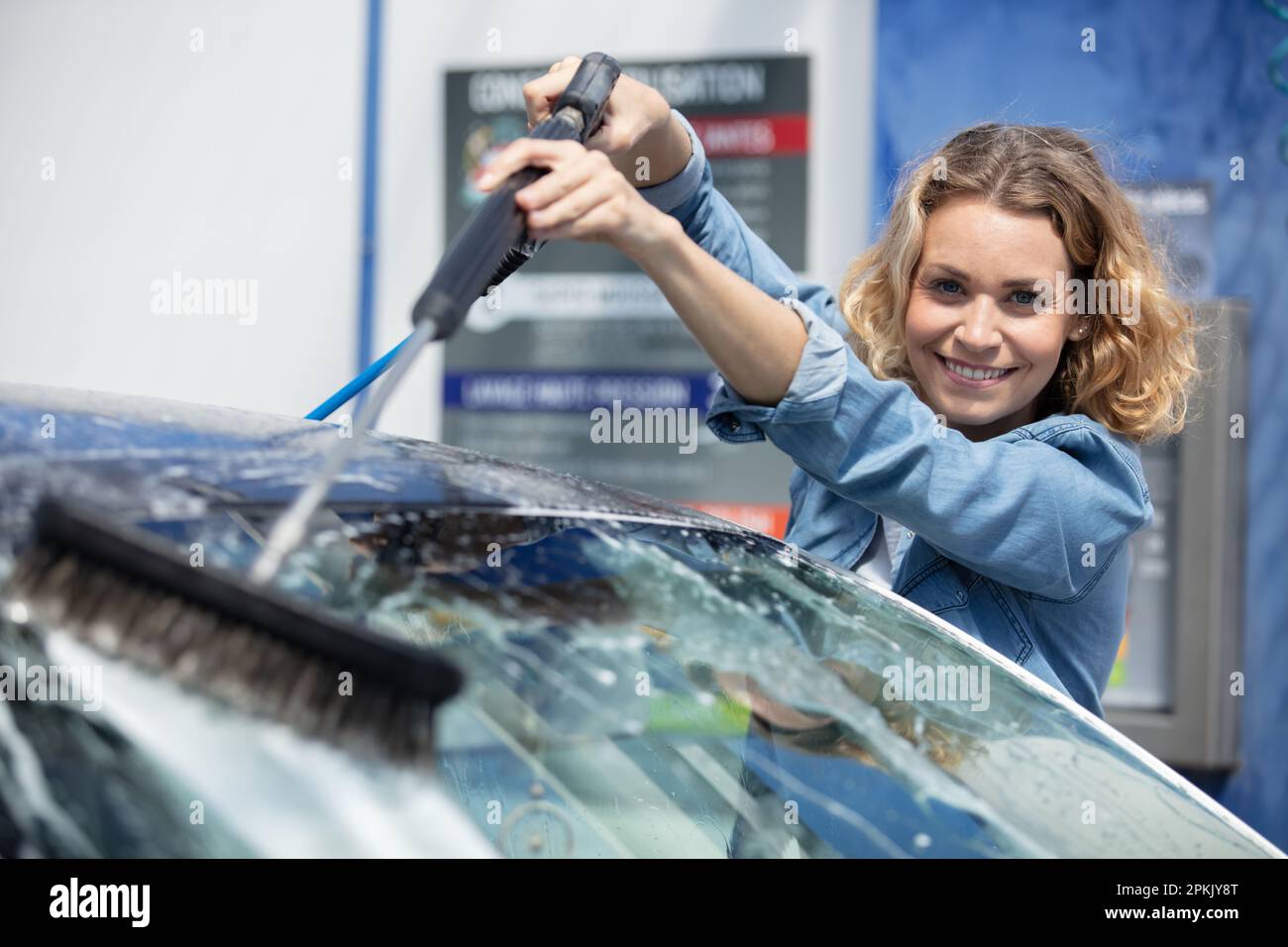 Attractive woman washing window hi-res stock photography and images - Alamy