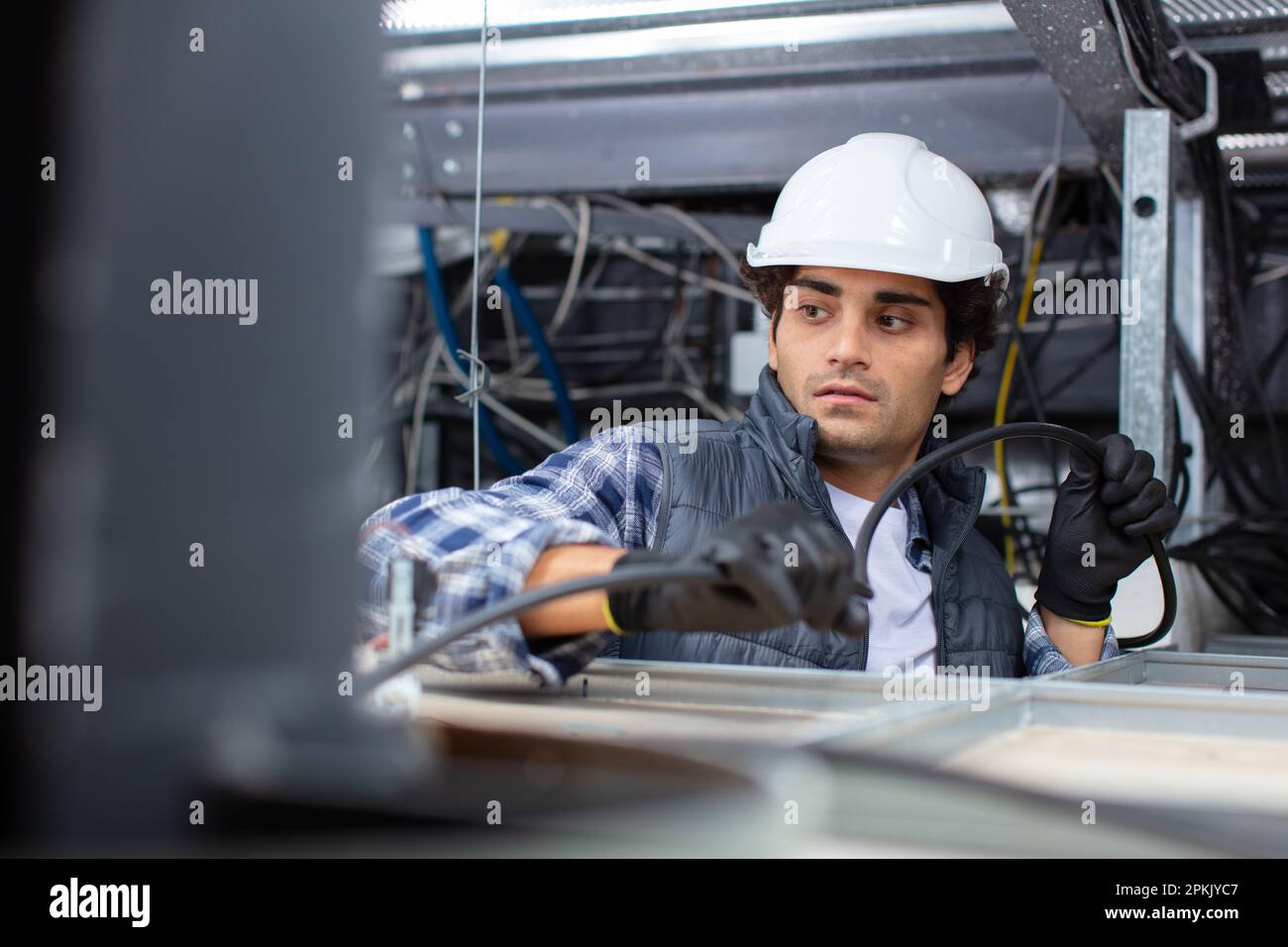 young man electrician wiring inside ceiling Stock Photo - Alamy