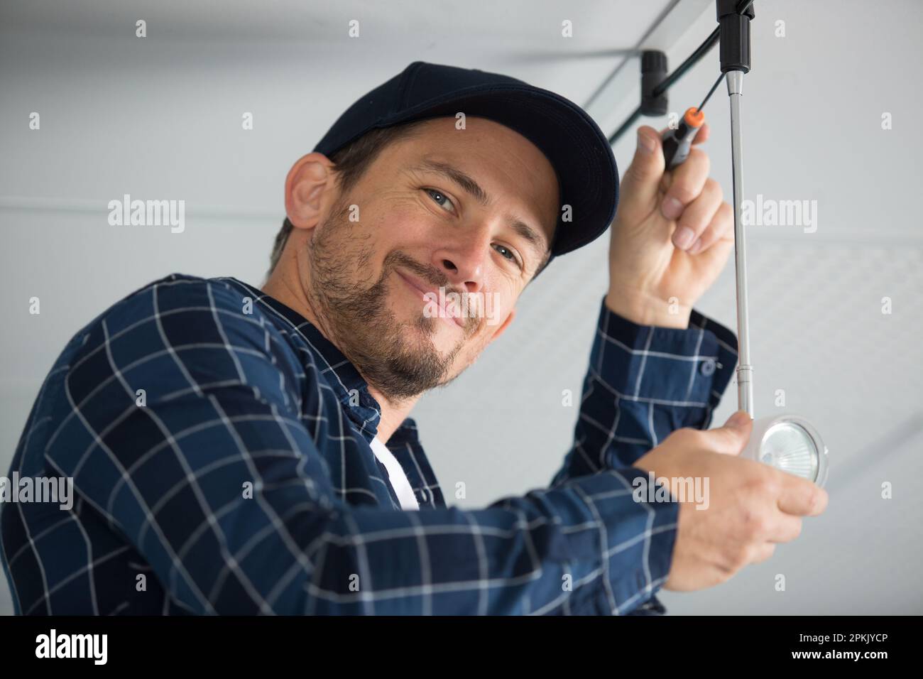 happy man in blue cap smiling at the camera Stock Photo - Alamy