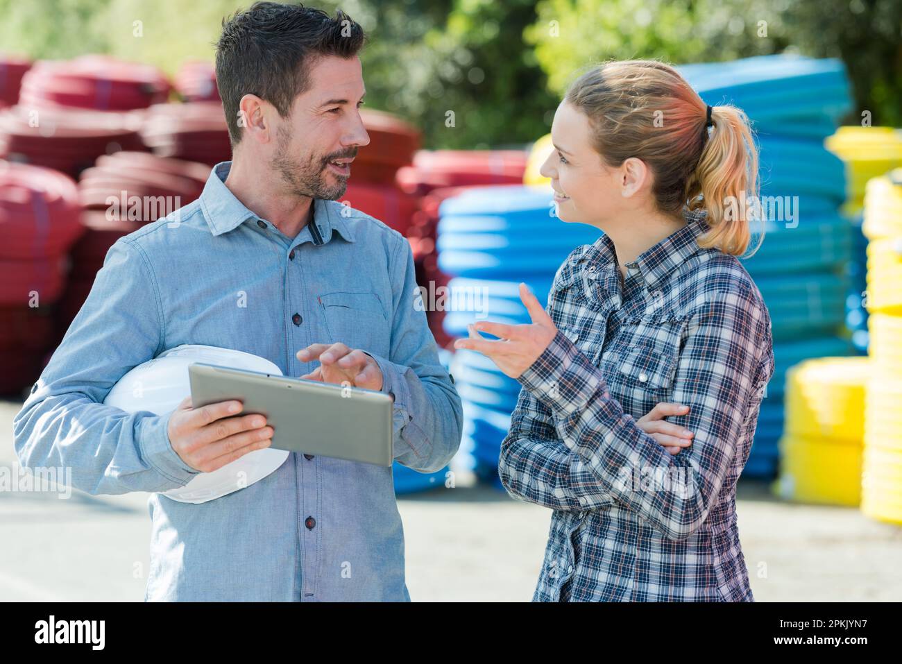 man and woman in materials yard holding tablet Stock Photo - Alamy